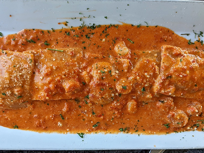 Lobster ravioli swimming in a sauce so good you'll be plotting ways to soak up every last drop.