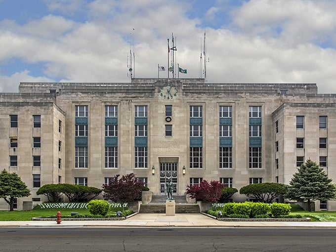 Macon County's imposing limestone courthouse stands as a monument to mid-century civic architecture, when government buildings were designed to inspire awe.