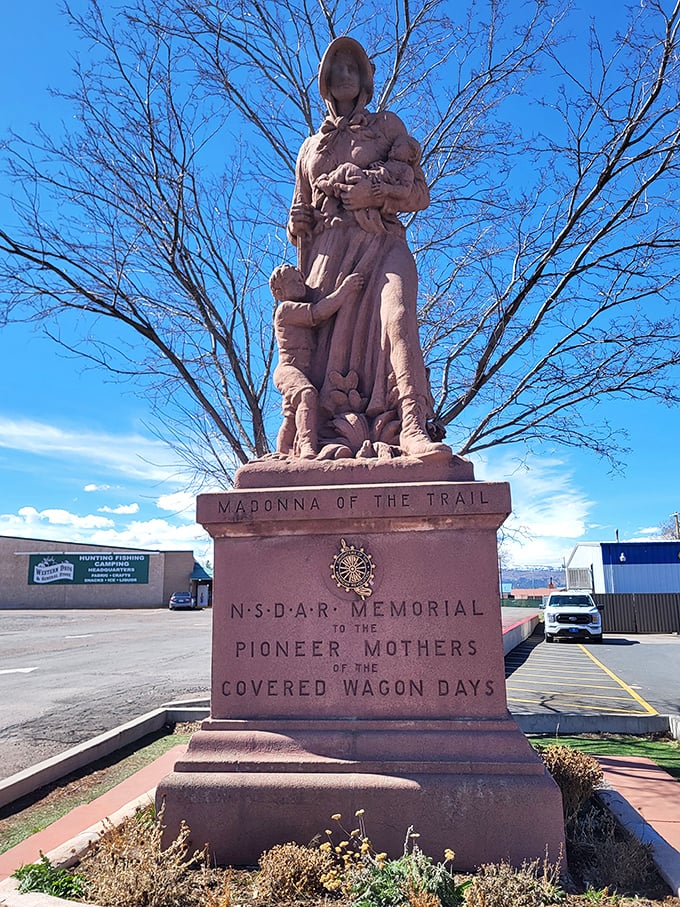 The Madonna of the Trail statue honors pioneer women with the kind of quiet dignity that makes your smartphone scrolling suddenly seem trivial.