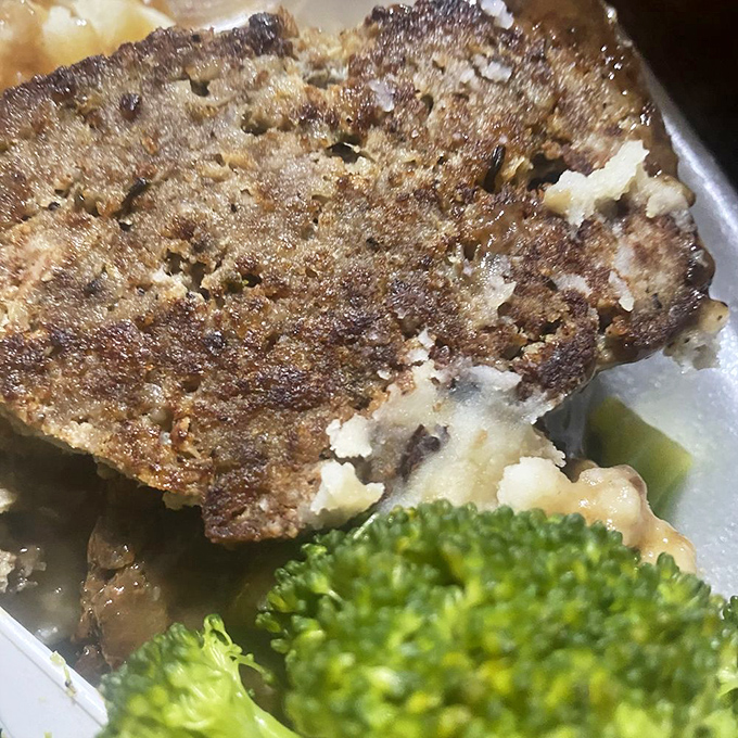 Comfort on a plate: hearty meatloaf with a side of broccoli that would make your grandmother nod in approval.