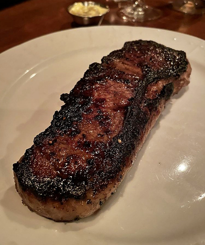 The New York Strip arrives with the confidence of a heavyweight champion—charred exterior, rosy interior, and enough flavor to make vegetarians question their life choices.