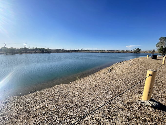 North Gateway Park's serene waters reflect Colorado's endless blue skies, offering a peaceful fishing spot where the biggest catch is often a moment of perfect tranquility.