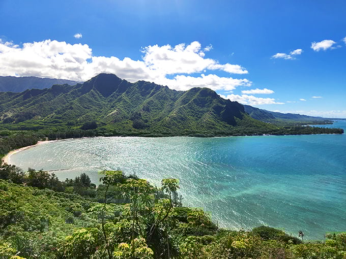 The view that makes you question why you ever waste time indoors. Kahana Bay's waters shift between emerald and turquoise as clouds dance overhead.
