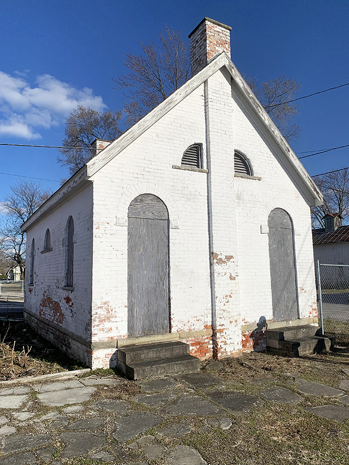 This humble white brick building whispers stories of simpler times, standing as a preserved piece of Genoa's practical past.