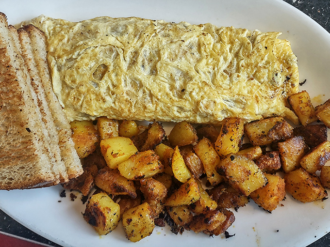 An omelet should be a perfect golden envelope delivering delicious contents, and this one doesn't disappoint &ndash; paired with home fries that deserve their own fan club.