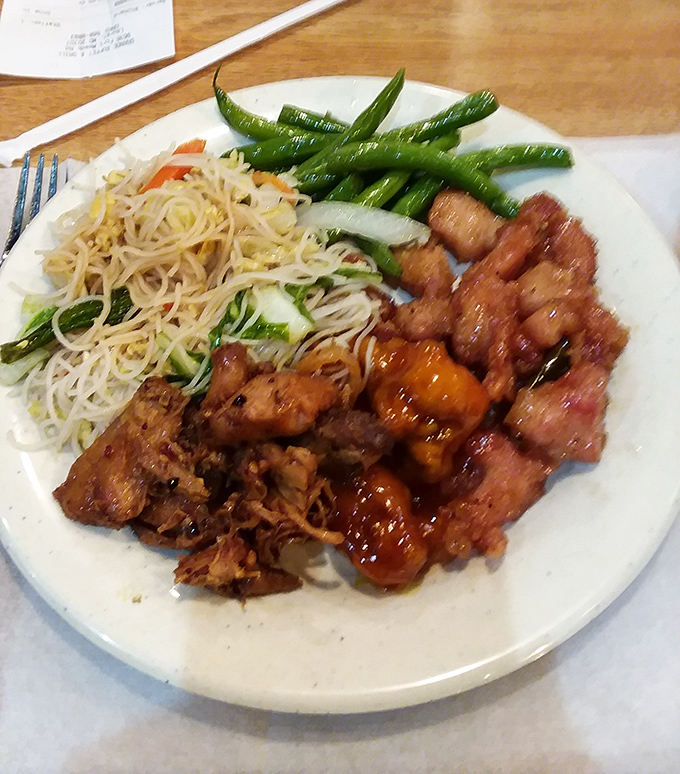 A plate that tells a story: crispy orange chicken, stir-fried noodles, and green beans&mdash;the holy trinity of buffet satisfaction.