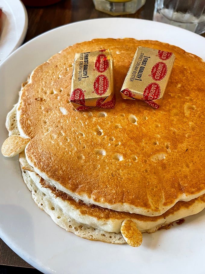 Pancakes so perfectly golden they deserve their own Alaskan gold rush. Those butter pats aren't melting&mdash;they're surrendering to inevitable deliciousness.