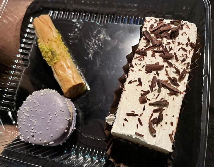 This almond croissant wears its powdered sugar like a winter coat, promising layers of buttery pastry and rich almond filling within.