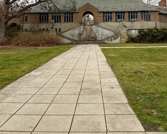 A pathway of perfect symmetry leads to architectural intrigue. Even in winter's dormancy, the grounds maintain their dignified charm&mdash;like a distinguished gentleman in repose.