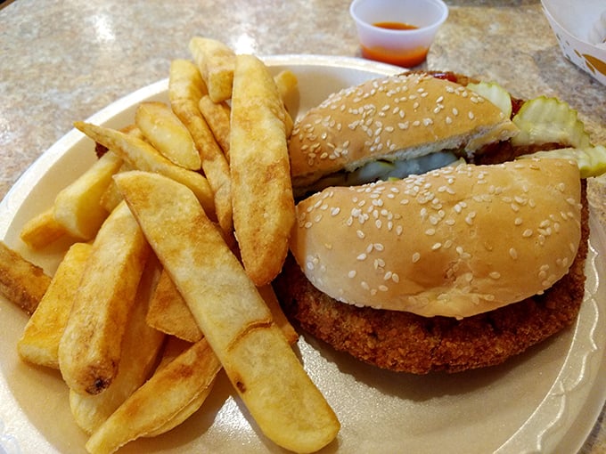 Golden-fried perfection on a sesame bun. This pork tenderloin sandwich with crispy fries is Midwestern comfort food that speaks a universal language.