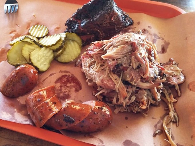 Pulled pork so tender it practically pulled itself. Paired with house-made sausage and pickles that cut through the richness like witty banter.