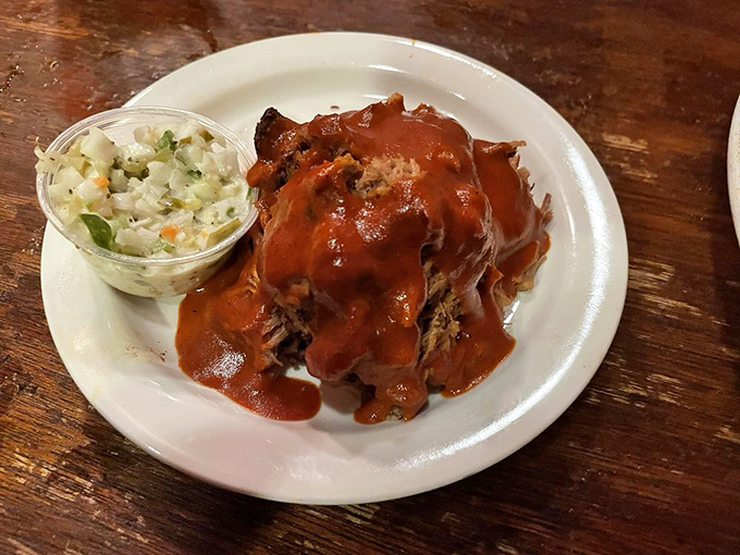 That pulled pork looks like it's taking a luxurious sauce bath. The coleslaw isn't a side&mdash;it's a cooling agent for your taste buds.