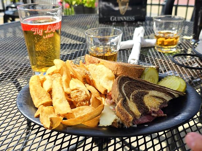 The Reuben sandwich in its natural habitat &ndash; marble rye embracing corned beef, with chips that look like they're auditioning for a food magazine cover.