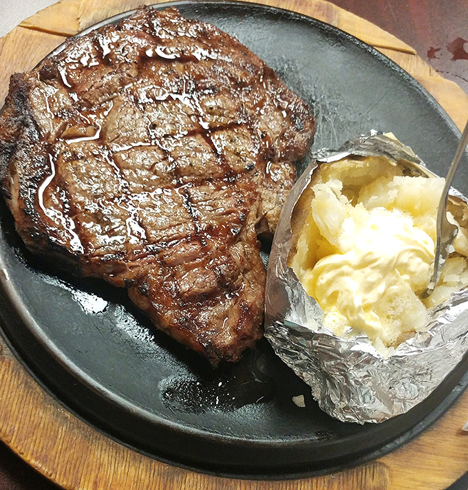 Glistening with juices and sporting a crust that would make any carnivore weak in the knees. The baked potato stands by, ready for duty.