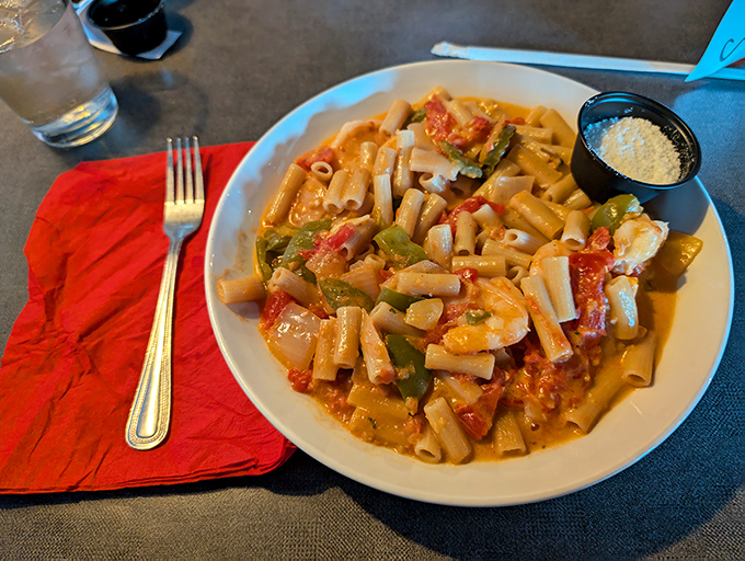 Rigatoni that doesn't just sit on the plate but stands at attention, each tube a perfect vessel for that vibrant tomato sauce.