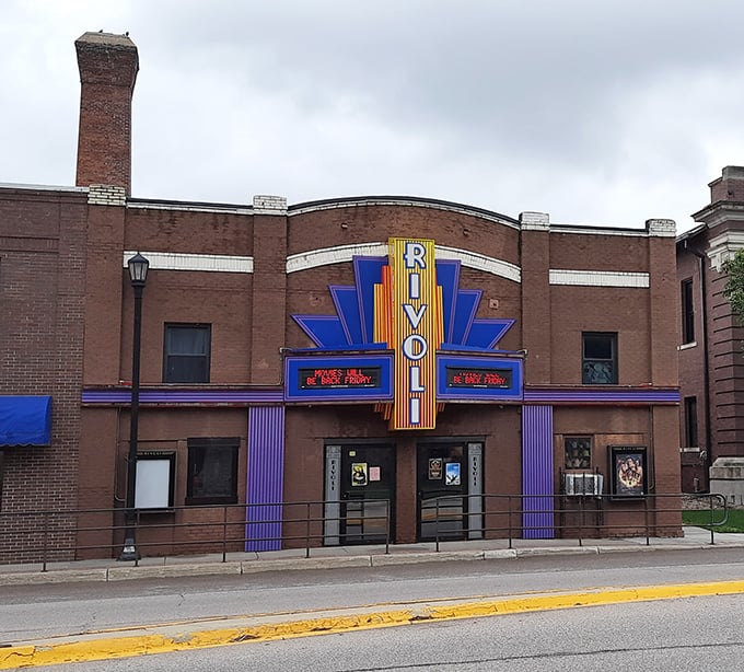 The Rivoli Theater's neon marquee glows like a beacon from another era, when movie nights were community events.