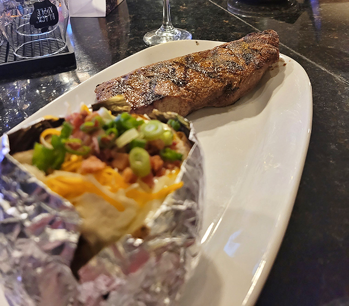 A sirloin that's been kissed by fire and blessed by seasoning, paired with a loaded potato that's dressed for the occasion.