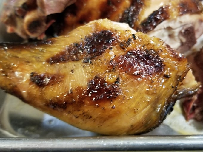 Chicken skin crisped to golden perfection, hiding meat so juicy it should come with a warning label and a stack of napkins.