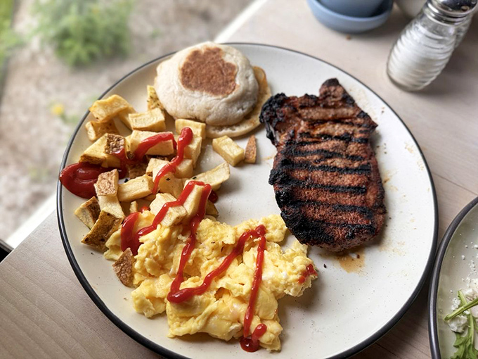 This breakfast plate means business: a perfectly grilled steak, fluffy eggs, and home fries that could make a werewolf forget about the full moon.