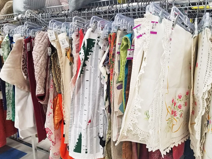 Vintage linens and delicate embroidery hang like textile time capsules, each piece whispering stories of dinner parties past.