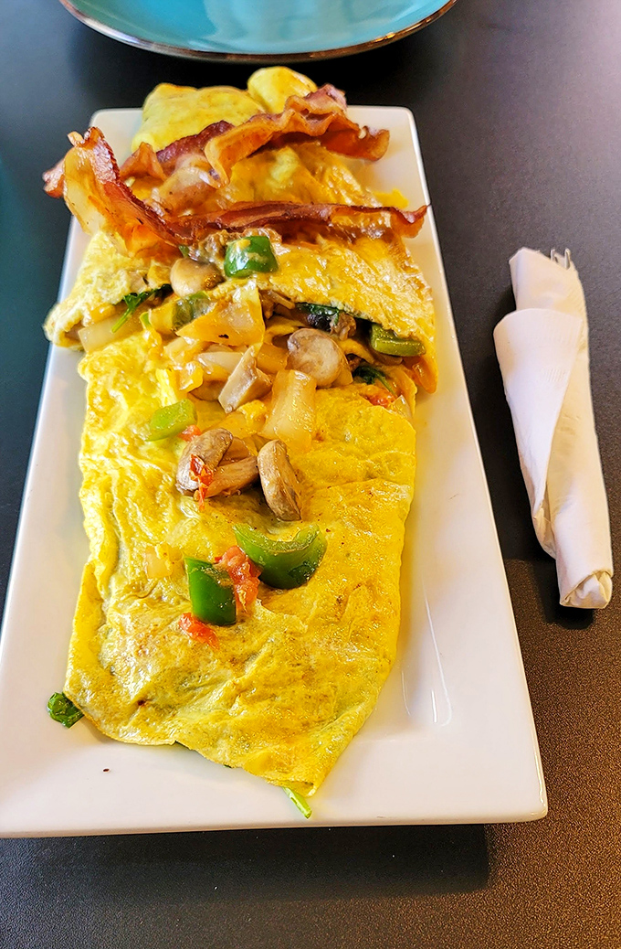 This isn't just an omelet&mdash;it's a flavor festival where peppers, mushrooms, and bacon have gathered to throw the day's best party.