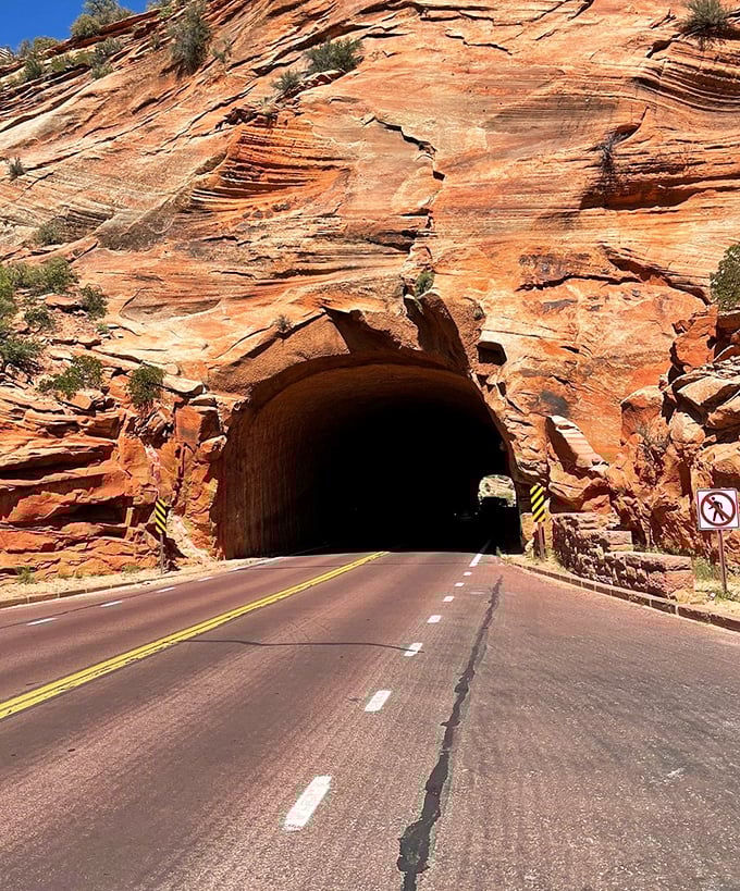 Not your average highway underpass! This tunnel, carved through solid sandstone, feels like driving through Earth's own time capsule.
