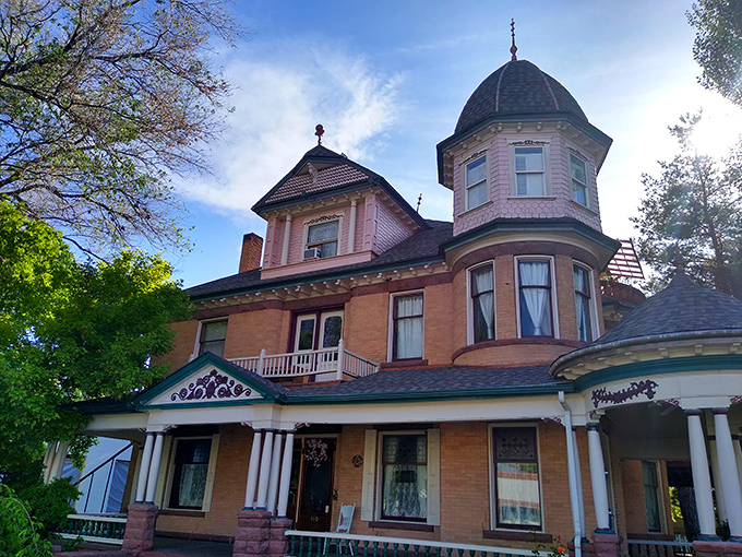The Whitmore Mansion whispers tales of Victorian elegance, its turret and wraparound porch straight from another era.