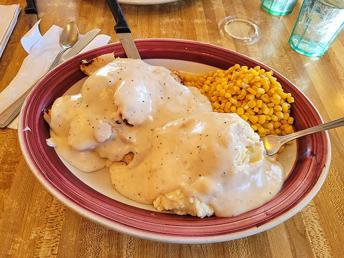 Biscuits and gravy that would make a Southern grandmother nod in approval, served with a side of sweet corn. Comfort defined.