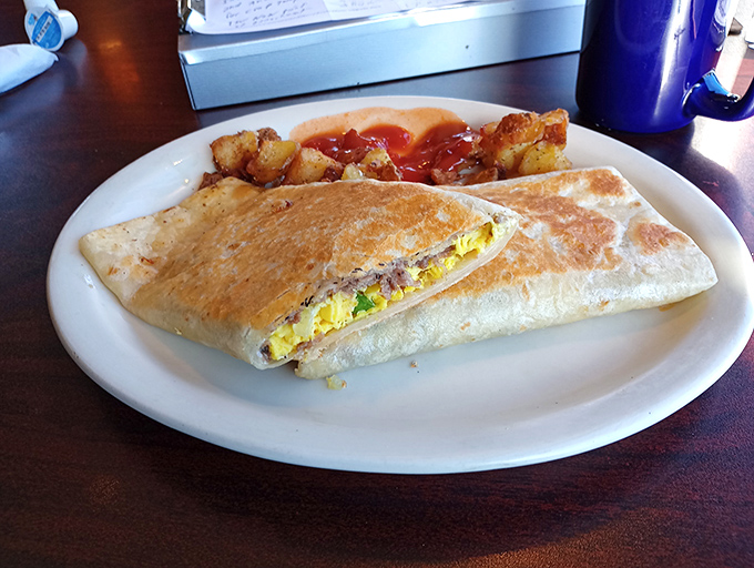 The breakfast wrap &ndash; where eggs, meat and cheese find their perfect home, nestled beside home fries kissed by ketchup.