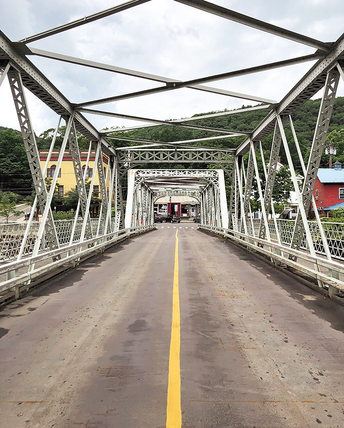 The Iron Bridge stretches across the Deerfield River like a steel handshake between Shelburne and Buckland, inviting you to cross and explore.