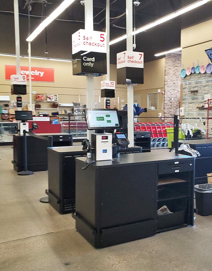 Self-checkout stations await your treasures. The jewelry counter in the background holds potential gems for eagle-eyed bargain hunters.