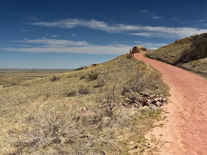 The path beckons like nature's red carpet, leading visitors from ordinary prairie to extraordinary geological celebrity in just a few steps.