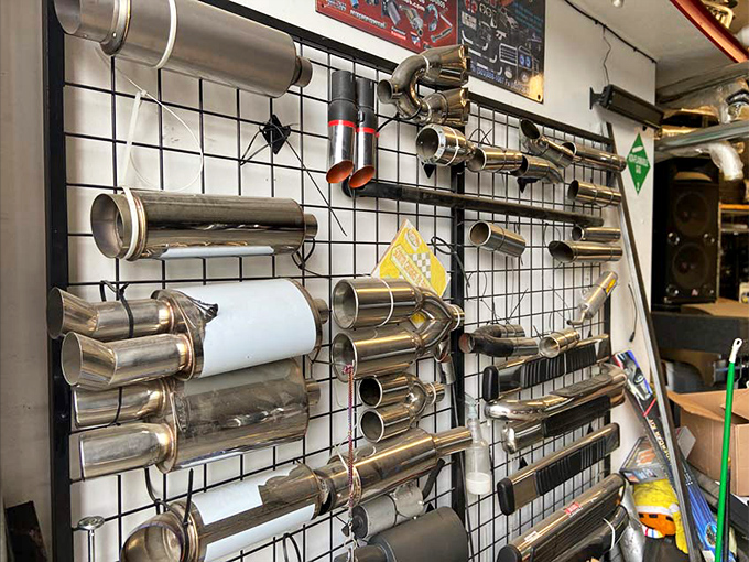 Car enthusiasts, rejoice! This wall of gleaming exhaust pipes is mechanical jewelry for your ride &ndash; proving one person's auto part is another's treasure.