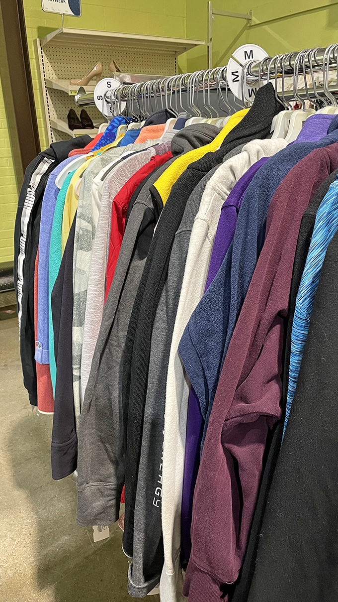 A rainbow of possibilities hanging neatly in a row. Your next favorite sweater is hiding somewhere in this textile treasure hunt.