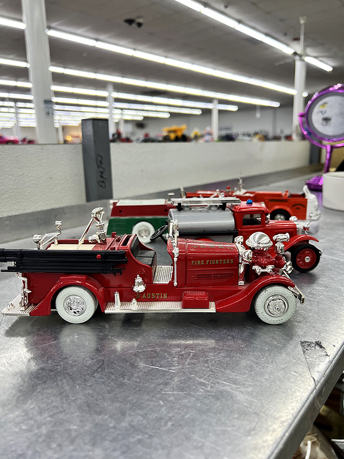 Collectible fire trucks wait patiently for someone who appreciates miniature emergency vehicles as much as the original owner clearly did.