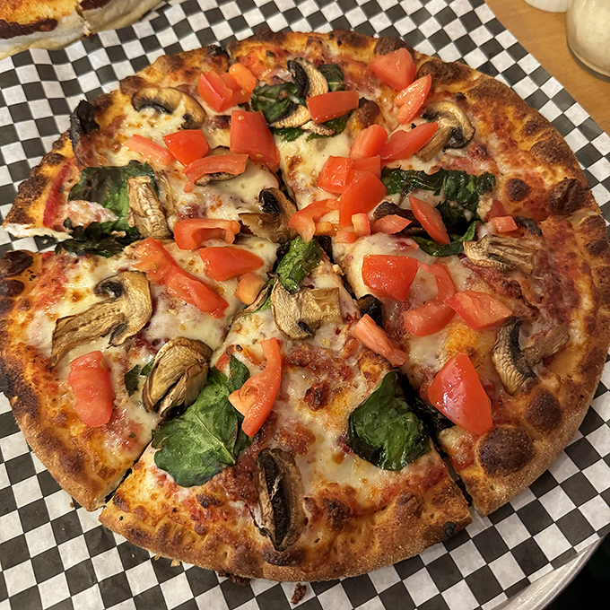 Garden-fresh ingredients dance atop this vegetarian masterpiece, proving that meatless options can still deliver heavyweight flavor.