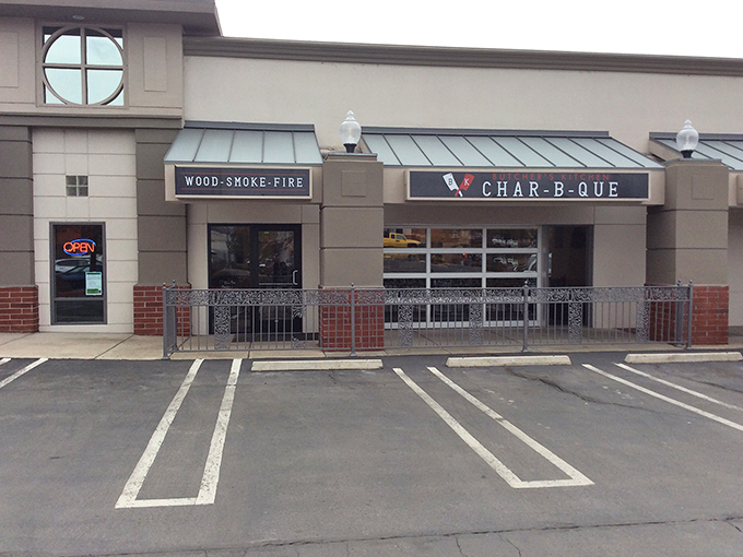 Butcher's Kitchen Char-B-Que's sleek storefront hints at their precision approach. "Wood-Smoke-Fire" isn't just a sign&mdash;it's a promise!