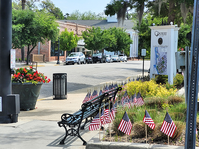Conway's historic downtown welcomes with American flags and tree-lined streets &ndash; small-town charm at its finest.