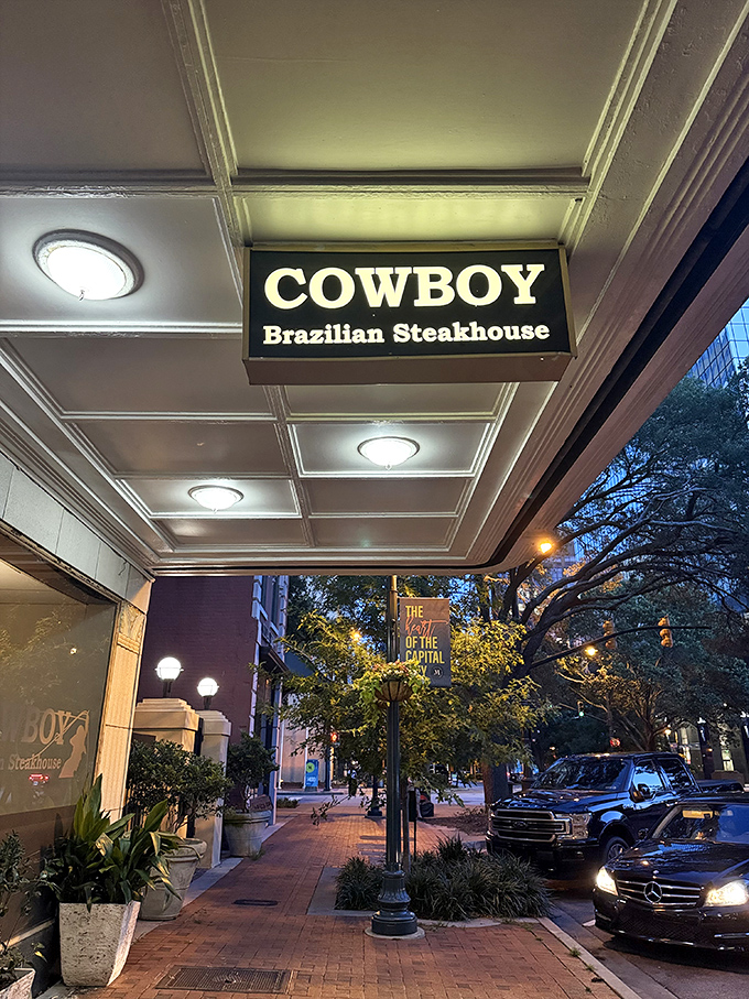 The glowing Cowboy Brazilian Steakhouse sign beckons meat lovers like a carnivore's North Star in downtown Columbia.