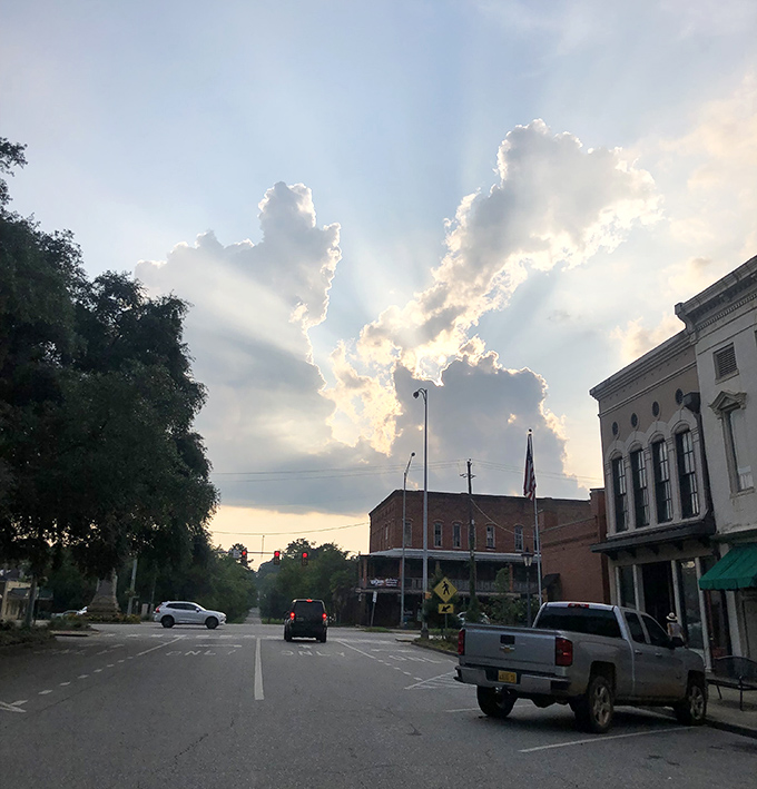 Breathtaking sunbeams break through clouds over Eufaula, Alabama, casting a magical glow across the town's peaceful and historic downtown streets.