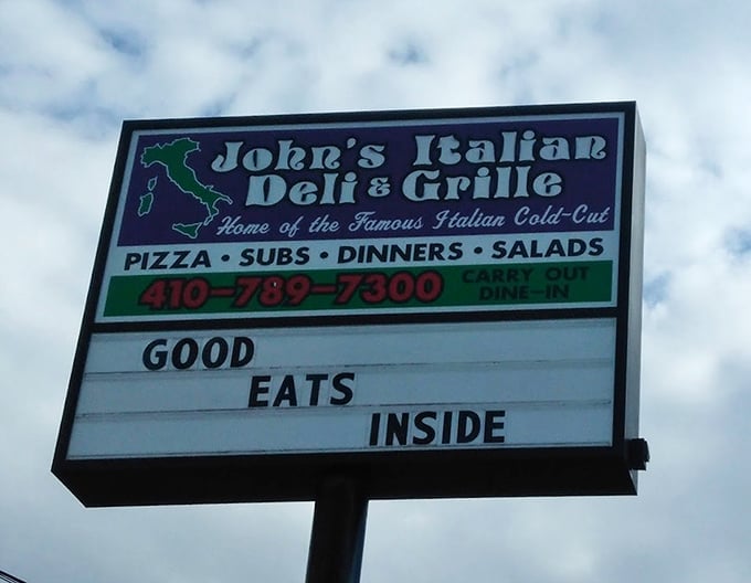 John's Italian Deli's straightforward sign makes a bold promise: "Good Eats Inside." In Baltimore, that's all the advertising you need.