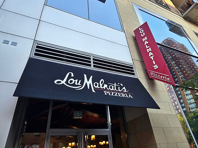 Lou Malnati's sleek downtown location blends modern style with pizza tradition. That black awning hides Chicago's cheesiest treasure.