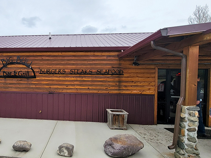 The Big Bull's log cabin exterior sets the perfect stage for wild game burgers &ndash; rustic charm with gourmet aspirations.