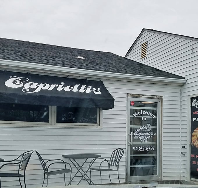 Clean lines and white columns frame Casapulla's entrance, where sandwich artistry happens daily behind those gleaming windows.