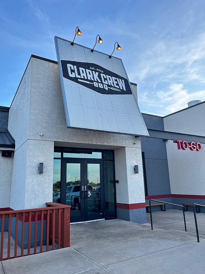 The towering Clark Crew BBQ sign stands like a beacon for hungry travelers. Those clean lines hide some seriously dirty-good BBQ.