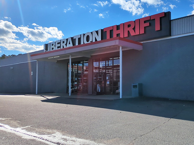 Liberation Thrift's bold red signage against gray walls makes a statement as strong as its mission. Richmond shoppers find both bargains and purpose here.