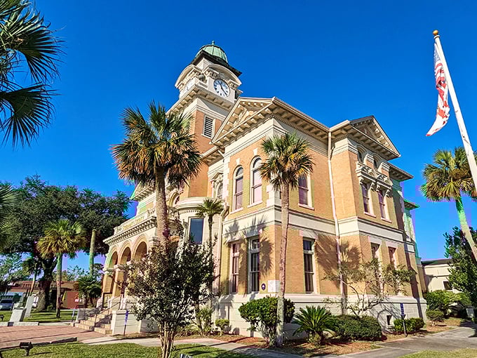 Enjoy the timeless beauty of the Suwannee County Courthouse in Live Oak, Florida, a historic gem framed by swaying palms.