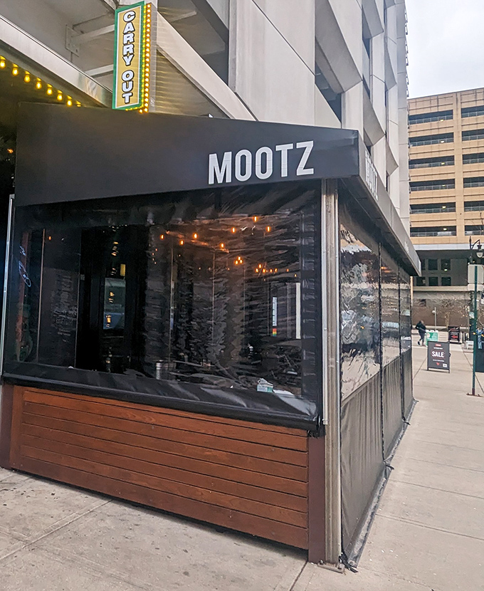 Where city sophistication meets neighborhood pizza joint vibes. Those lights are guiding hungry souls to pizza happiness.