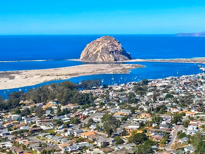 The waterfront village spreads beneath its famous guardian rock, creating postcard scenes that never get old.