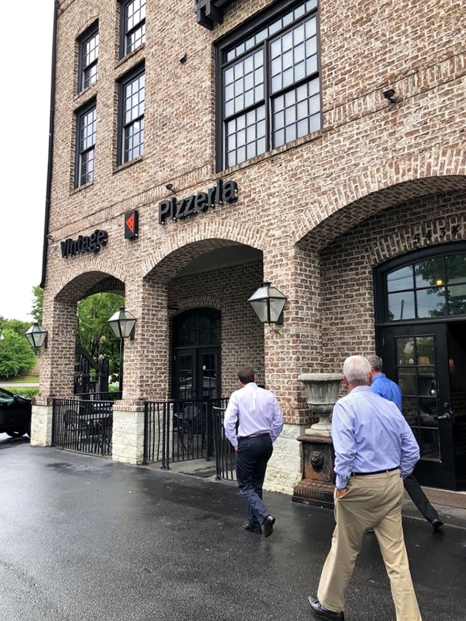 Rain can't keep pizza lovers away from Vintage's inviting doorway &ndash; some treasures are worth getting a little wet for!